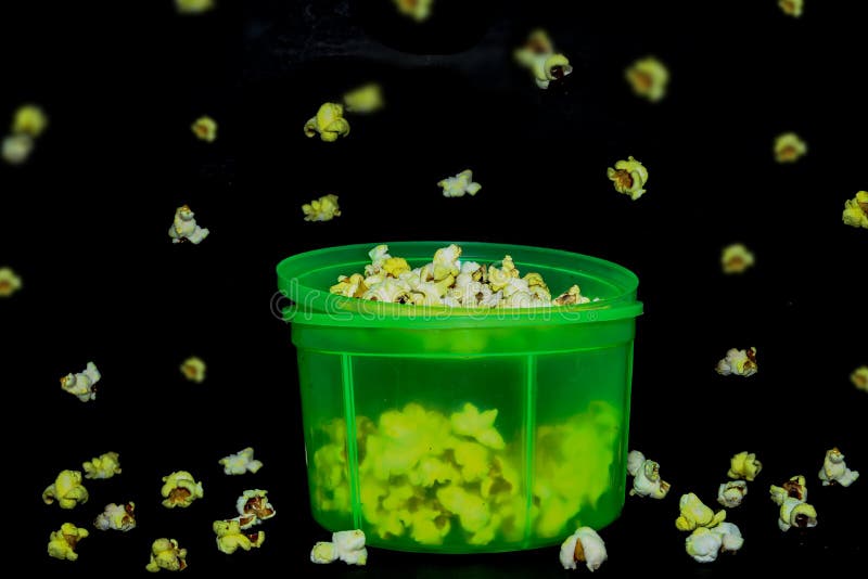 Popcorn Bucket with Falling Popcorn and Black Background Stock Image ...