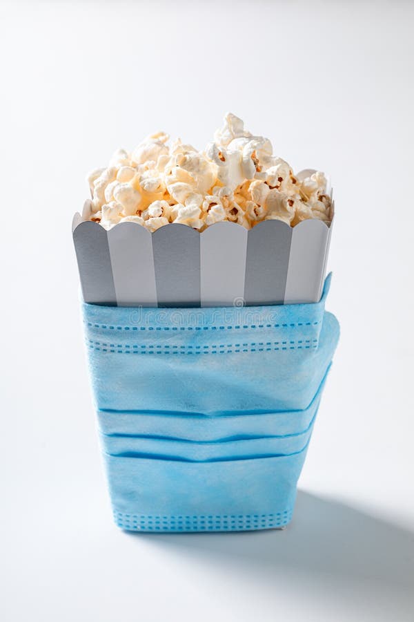 Popcorn and Disposable Mask. Concept of Covid Protective Treatments ...