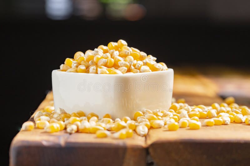 Popcorn Kernels in Bowl on Wooden Surface Stock Photo - Image of ...
