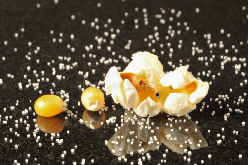Popcorn Kernels Surrounded by Salt Grains Stock Photo - Image of salty ...