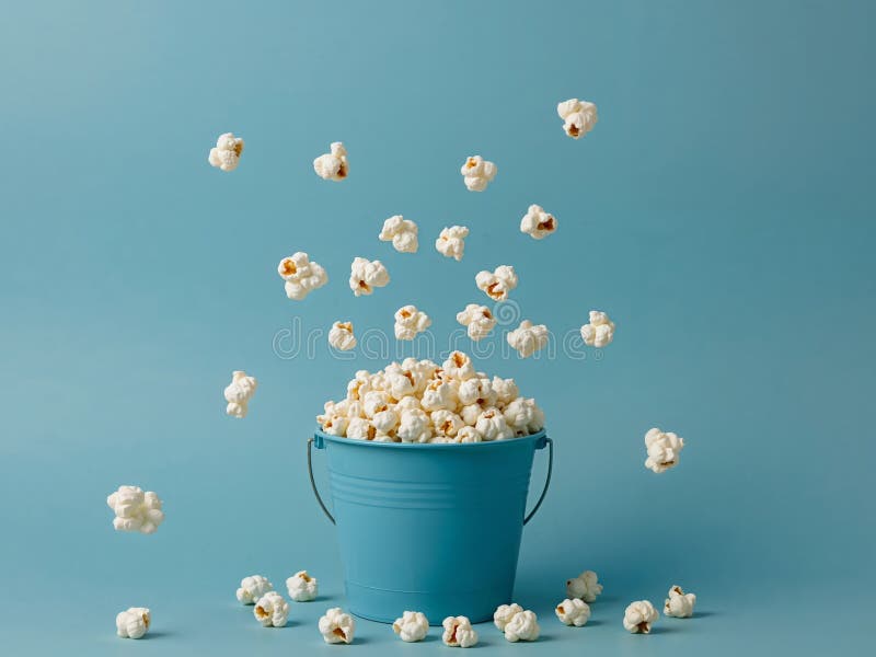 Popcorn Overflow. a Blue Bucket Filled with Delicious Treats on a Blue ...