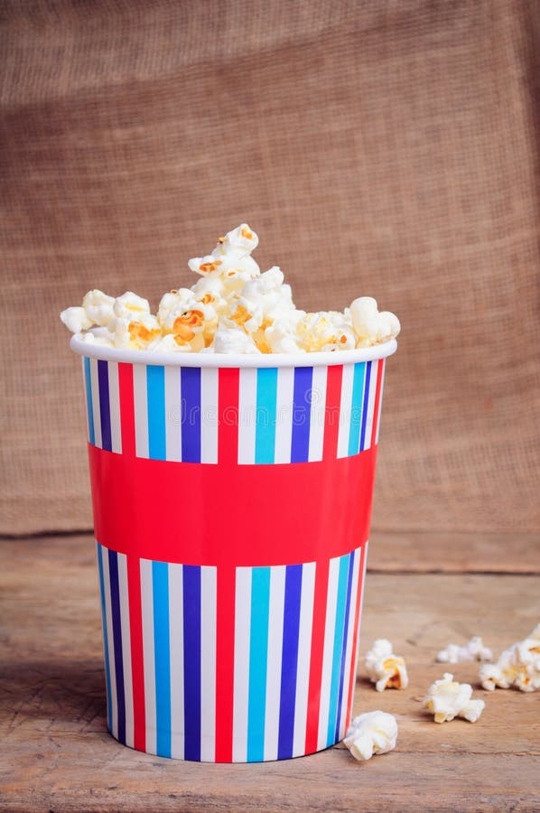 Popcorn in Paper Cup on Wooden Surface. Stock Photo - Image of popcorn ...