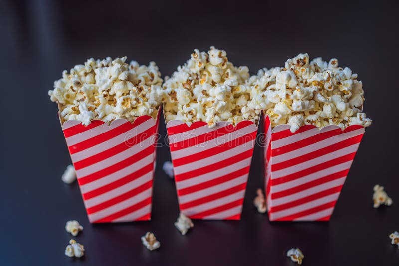 Popcorn in Red and White Container on a Dark Background BANNER, LONG ...