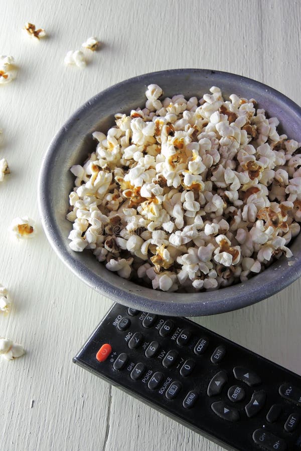 Popcorn and the TV remote stock photo. Image of control - 80015186