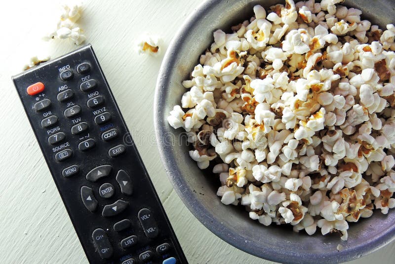 Popcorn and the TV remote stock photo. Image of heap - 80015200