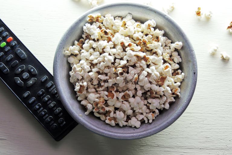 Popcorn and the TV remote stock image. Image of fluffy - 80015255