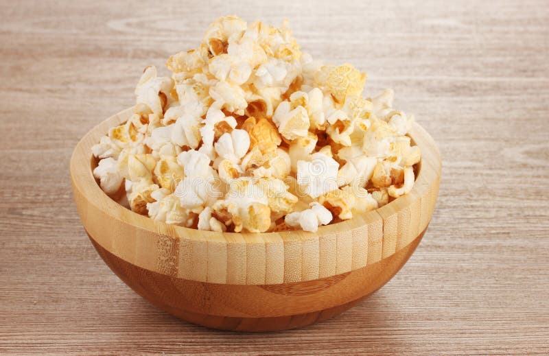 Popcorn in wooden bowl stock image. Image of greasy, nutrition - 23860257