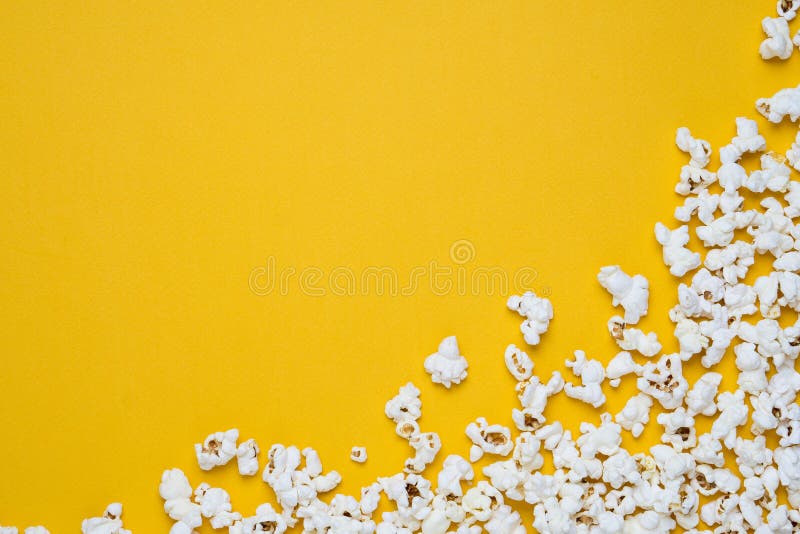 Popcorn on a yellow stock photo. Image of classic, entertainment ...