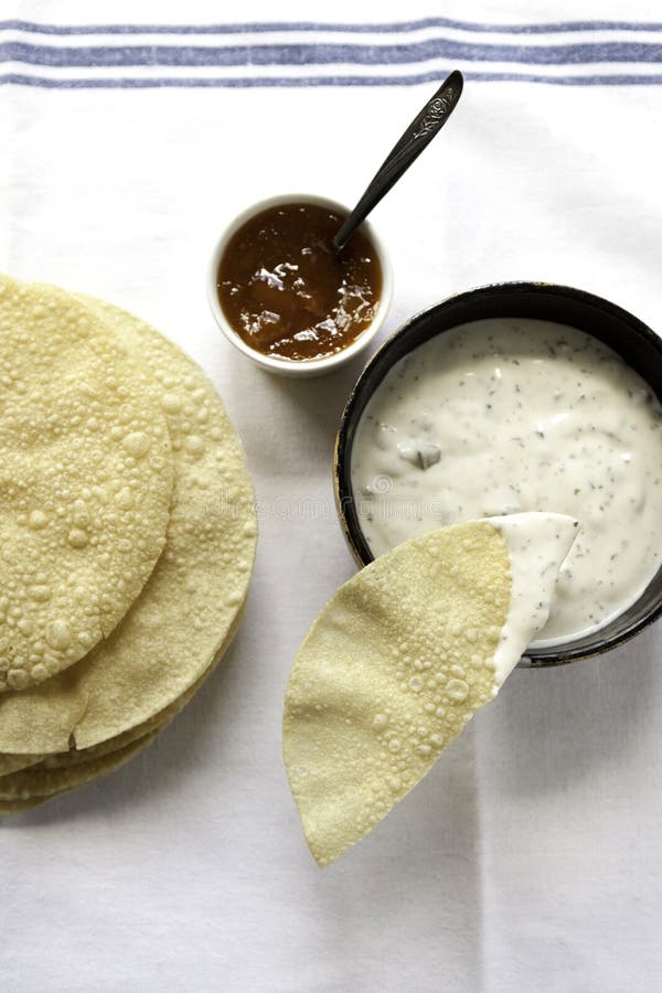 Poppadums with Mango Chuthey and Raita on the Table Stock Photo - Image ...