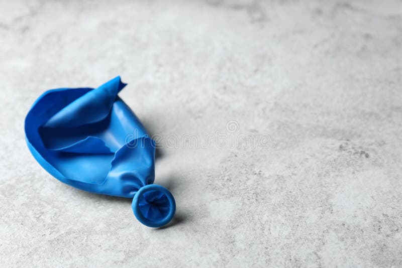 Popped blue latex balloon stock photo. Image of concept - 140614120
