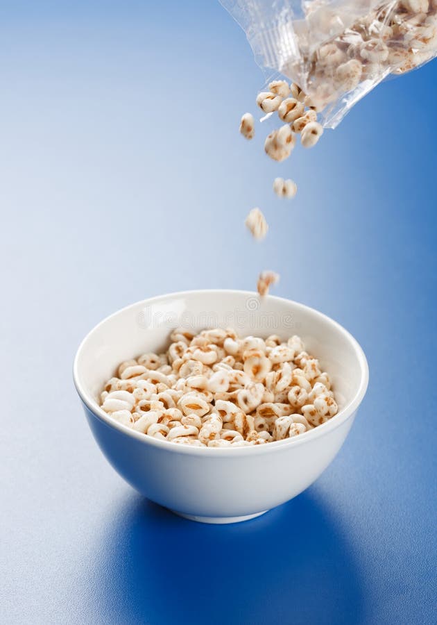 Popped Wheat Flakes Pouring in Plate Stock Image - Image of plastic ...