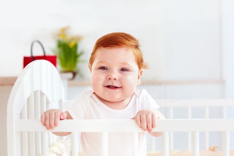 Poprtait of Cute Happy Infant Baby Standing in a Cot at Home Stock ...