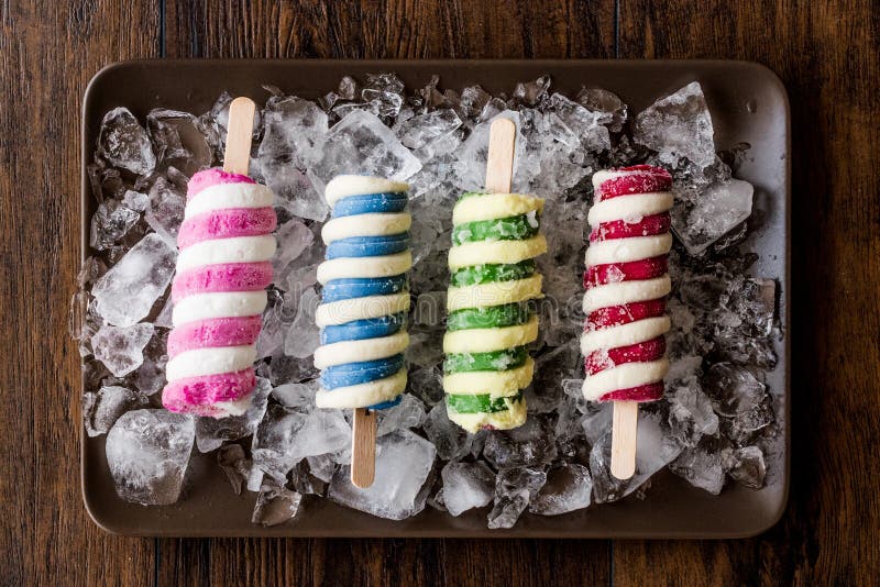 Popsicles Ice Cream with Ice on Dark Surface. Stock Image - Image of ...