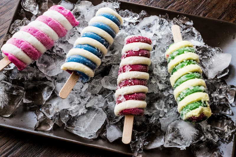 Popsicles Ice Cream with Ice on Dark Surface. Stock Photo - Image of ...
