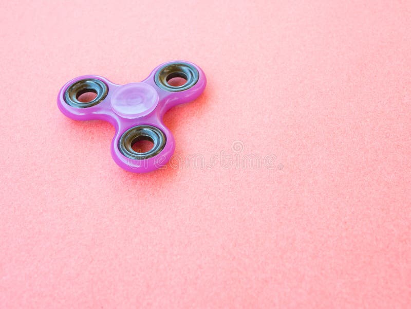 Popular Colourful Fidget Spinner Toy on a Colored Background Stock ...
