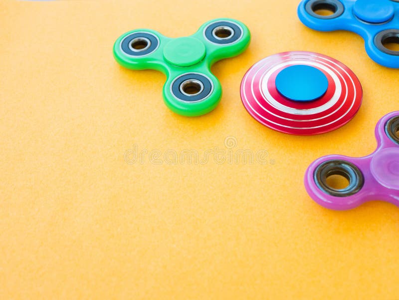 Popular Colourful Fidget Spinner Toy on a Colored Background Stock ...