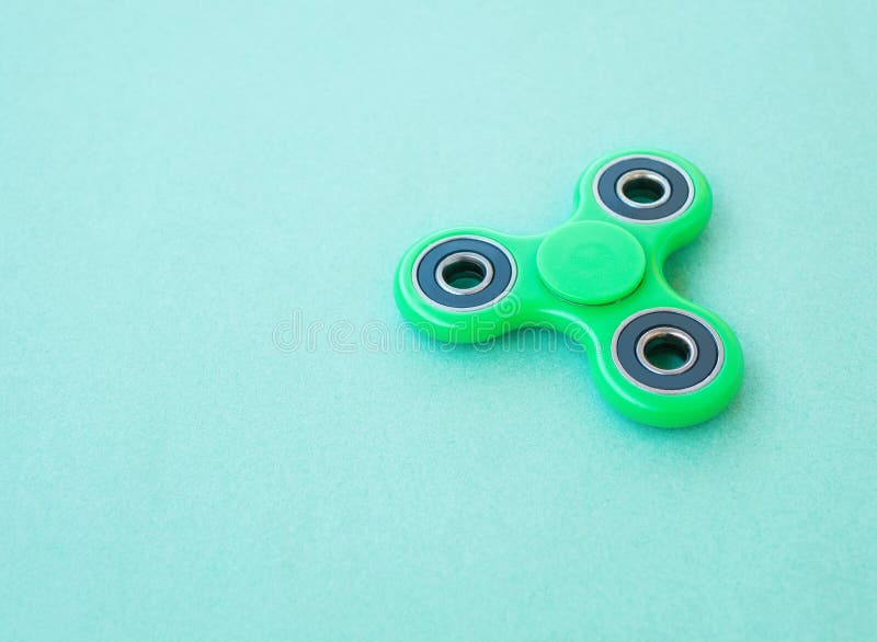 Popular Colourful Fidget Spinner Toy on a Colored Background Stock ...