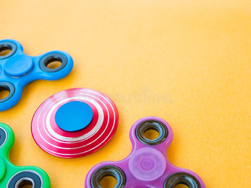 Popular Colourful Fidget Spinner Toy on a Colored Background Stock ...