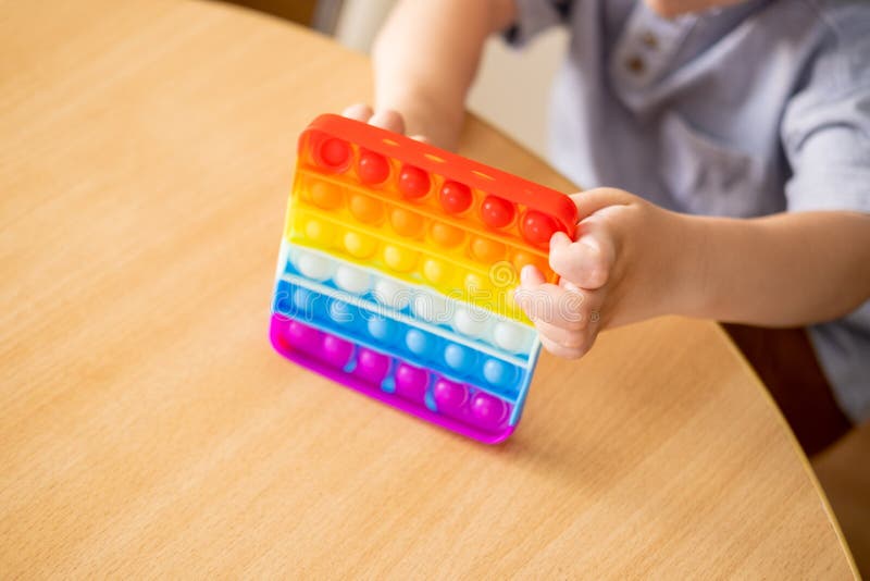 Popular Silicone Toy Pop it in the Hands of a Small Child Stock Image ...