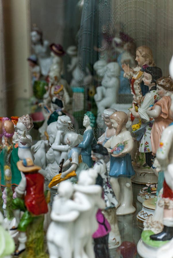 Assortment of Rare Porcelain Figurines on Glass Shelf Stock Photo ...