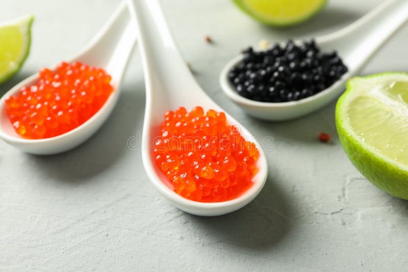 Porcelain Spoons with Caviar, Lime Slices and Spices Stock Photo ...