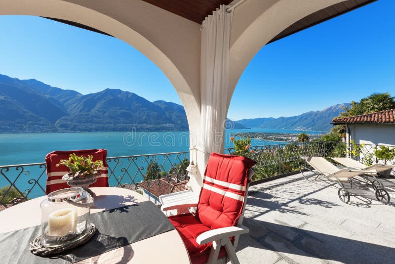 Nice Porch of the House with Painted Flower Beds and a Chair Stock ...