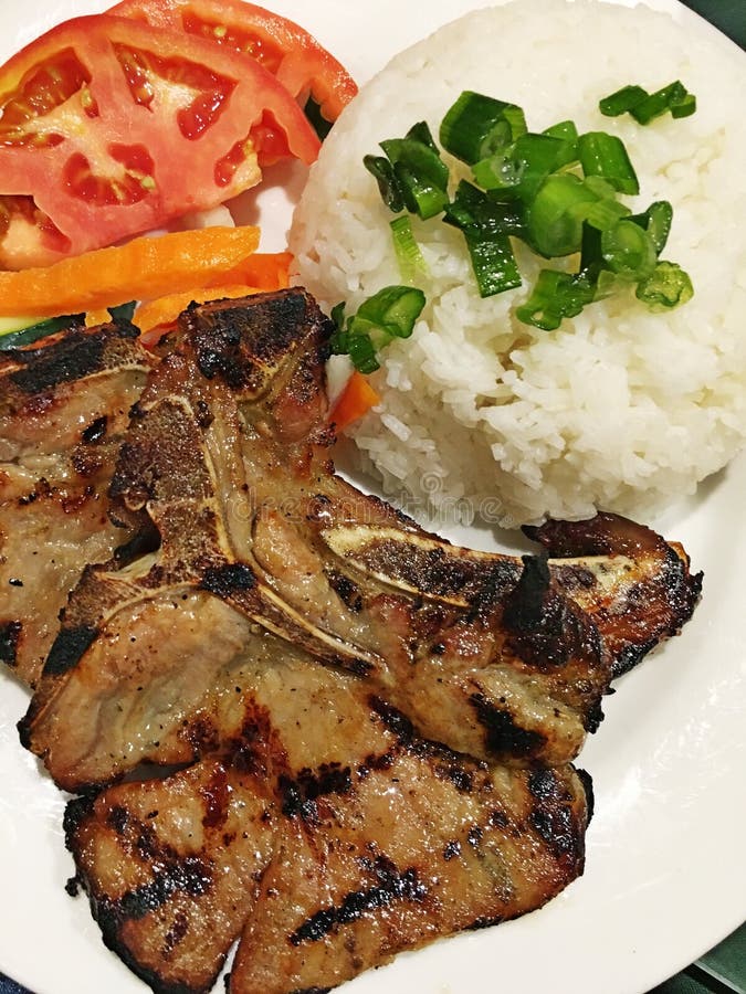 Pork chop over rice editorial stock image. Image of taste - 67229094