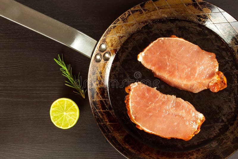 Pork Chop on a Steel Kitchen Pan. Fried Steak. Kitchen Utensils. Stock ...