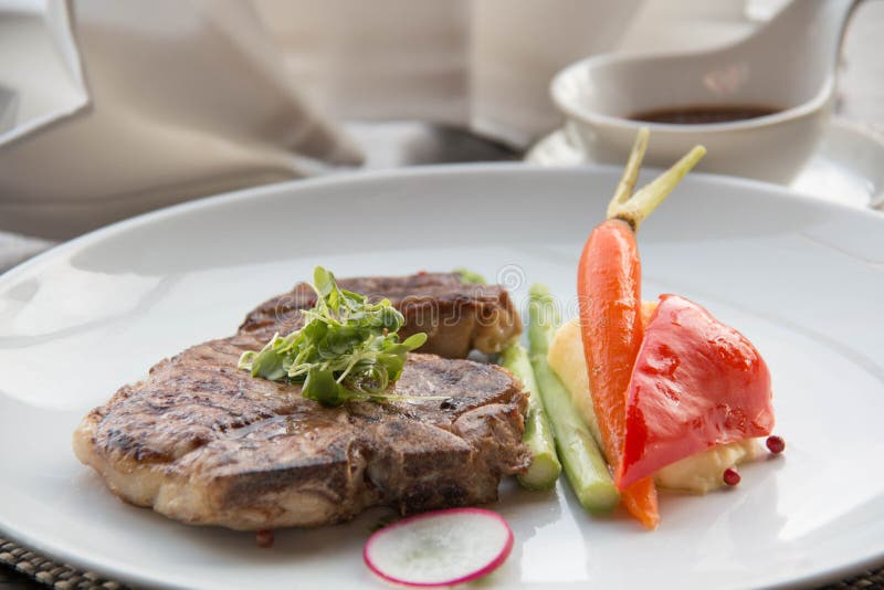 Pork chop on a white plate stock photo. Image of pork - 73420566