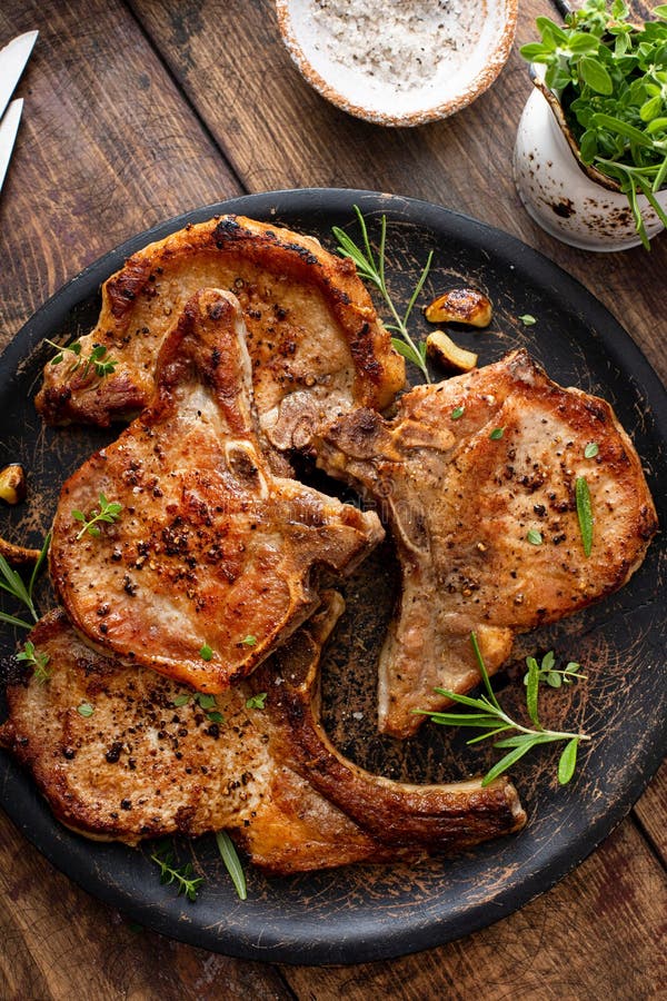 Pork Chops Grilled or Seared Bone in on a Serving Plate Stock Photo ...