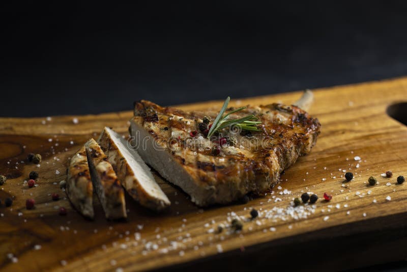 Pork Cutlet with a Bone on Rosemary and Pepper Stock Photo - Image of ...