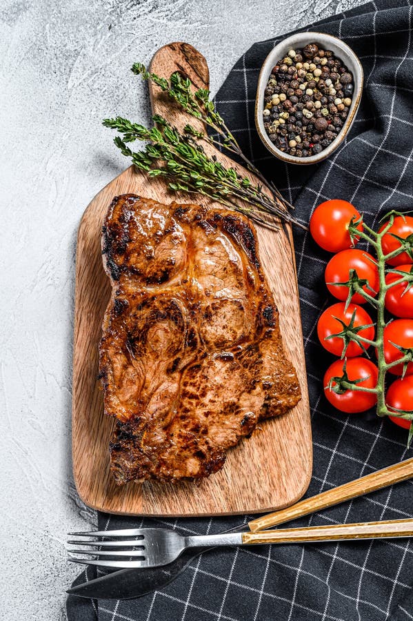 Pork Cutlet Steak on the Bone with Spices and Herbs. Gray Background ...