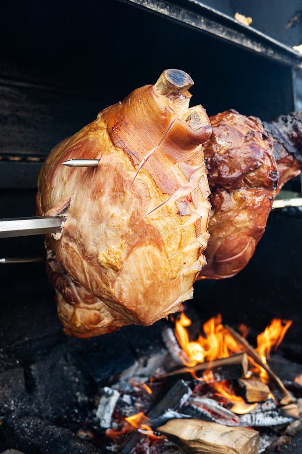 Pork Leg are Roasted on a Spit on a Grill Outside Stock Image - Image ...