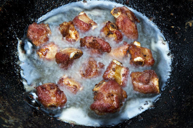 Pork in oil pan. stock image. Image of meal, bones, golden - 30450377