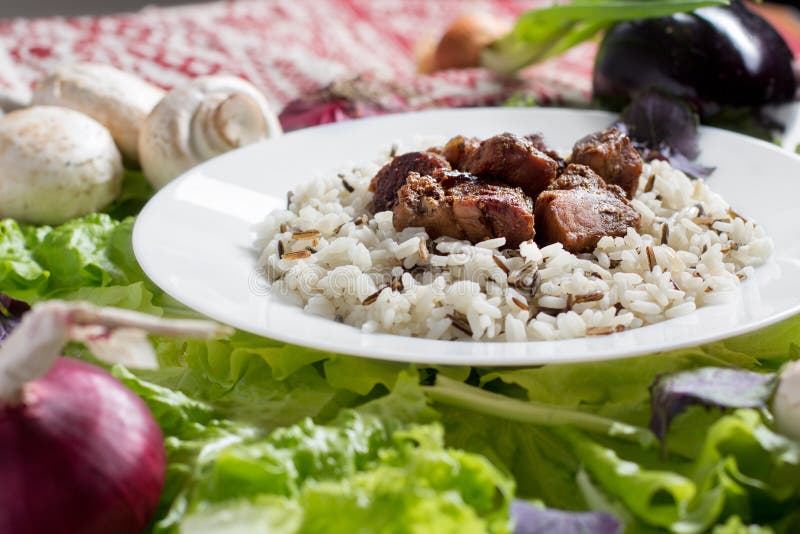 Pork Pieces with a Garnish from Brown Rice Stock Image - Image of ...