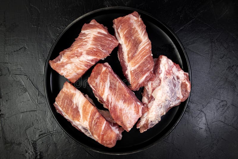 Pork Ribs on a Black Plate on a Stone Table, Top View, Fresh Pork Stock ...