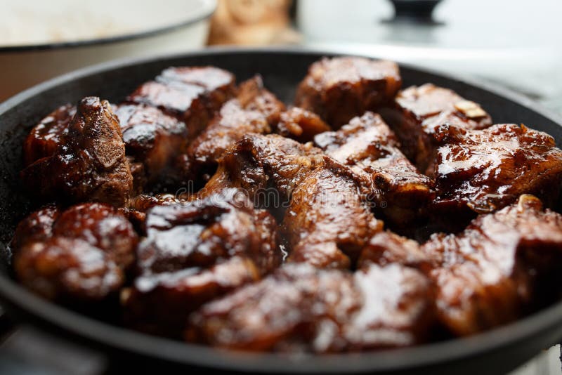 Pork ribs fried in a pan. stock image. Image of sauce - 108067217