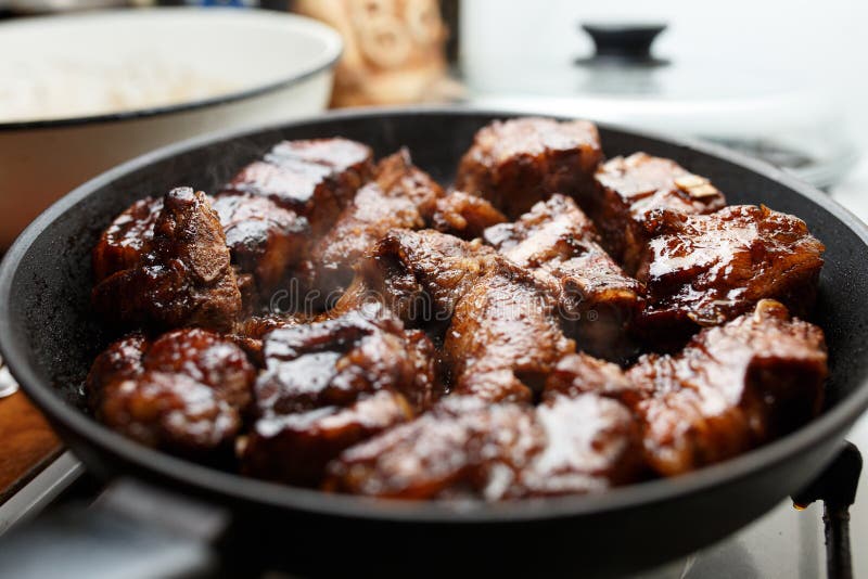 Pork ribs fried in a pan. stock photo. Image of brown - 108067266