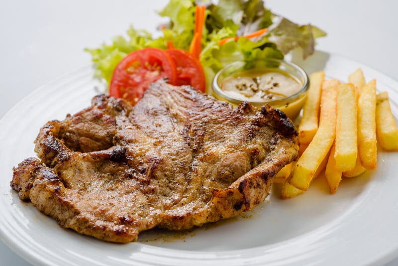 Pork Steak With French Fries And Salad On A White Background Stock Image Image Of Plate