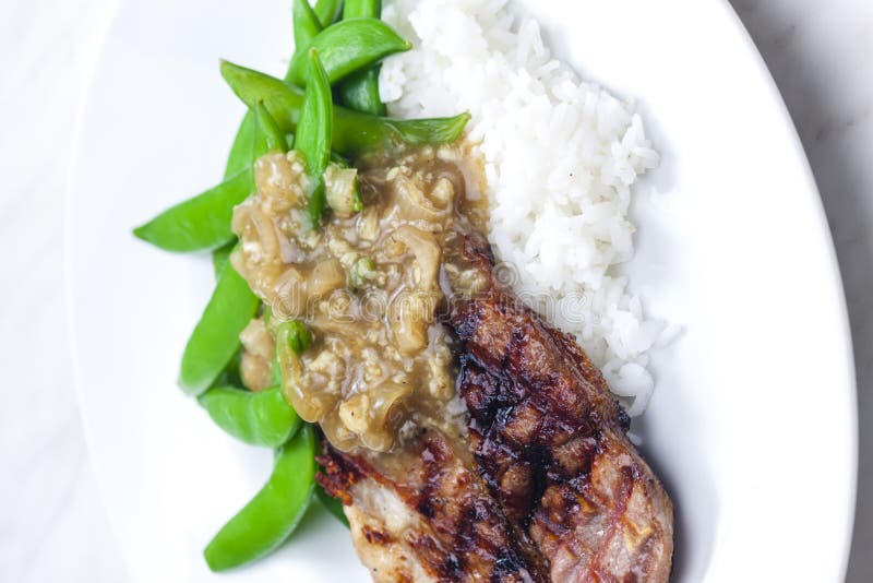 Pork Steak with Onion Sauce, Green Beans and Rice Stock Photo - Image ...