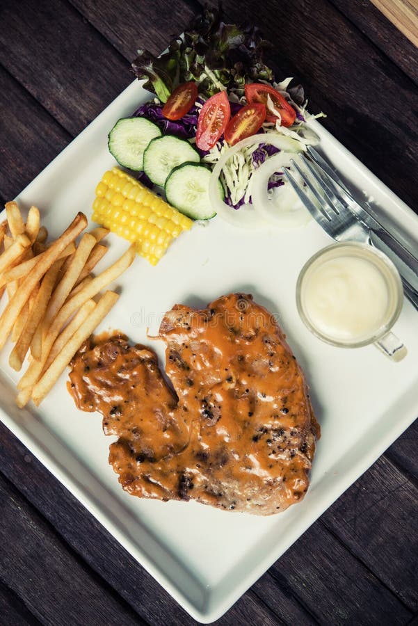 Pork Steak Set Placed on a Wooden Table Restaurant. Stock Image - Image ...