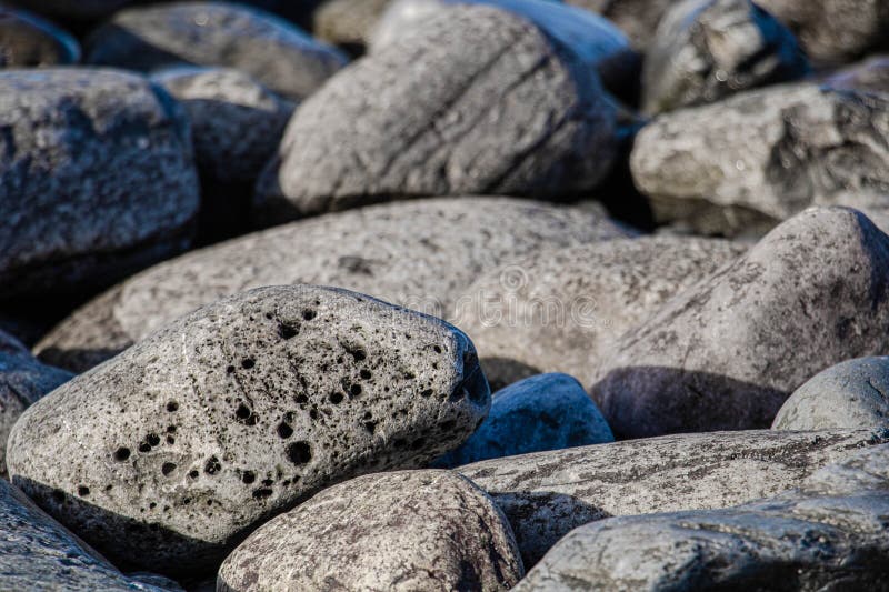 A Porous Rock Lies on a Rocky Beach Stock Photo - Image of edge ...