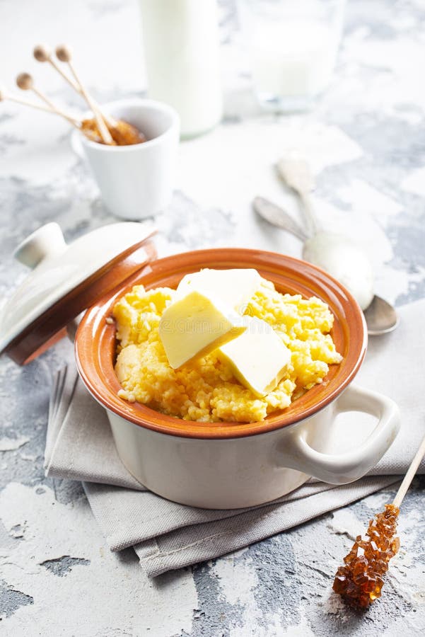 Porridge with Butter in Plate on Rustic Table Stock Photo - Image of ...
