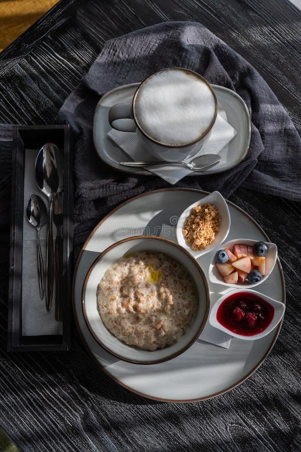 Porridge and Coffee. Served Breakfast in a Cafe. Vertical Photo. Stock ...