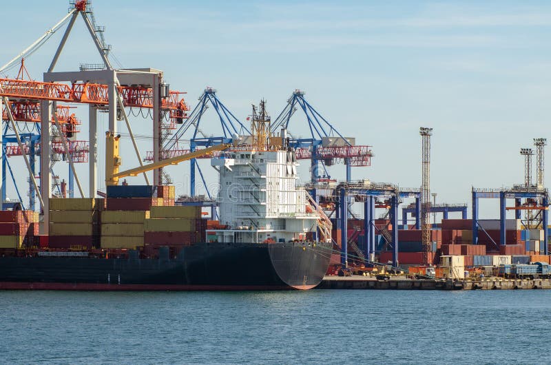 Port Cargo Crane Loads a Container Onto a Cargo Ship Stock Image ...