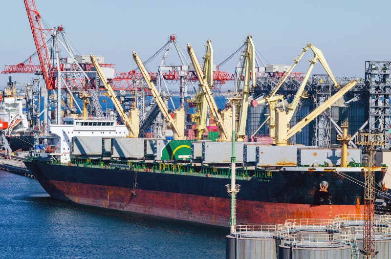 Port Cargo Crane Loads a Container Onto a Cargo Ship in a Seaport ...