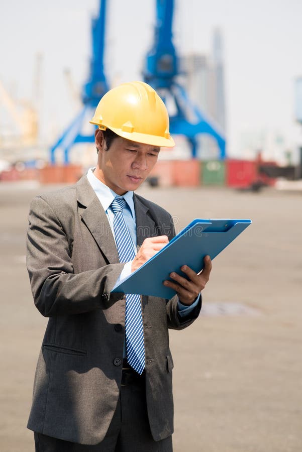 Seaport Inspector Busy with in-checking on Cargo and Pointing To ...