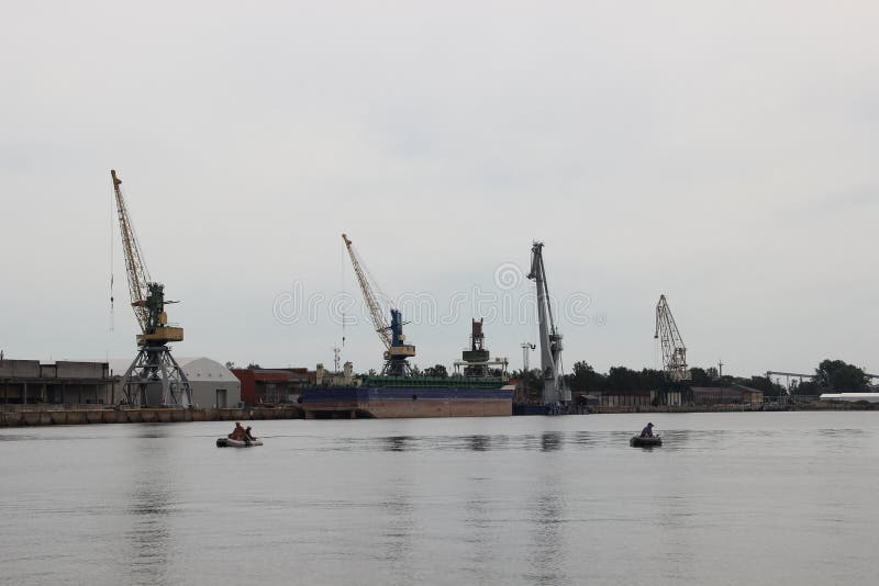 Port Terminal. Heavy Lifting Cranes Stand in a Row Stock Photo - Image ...