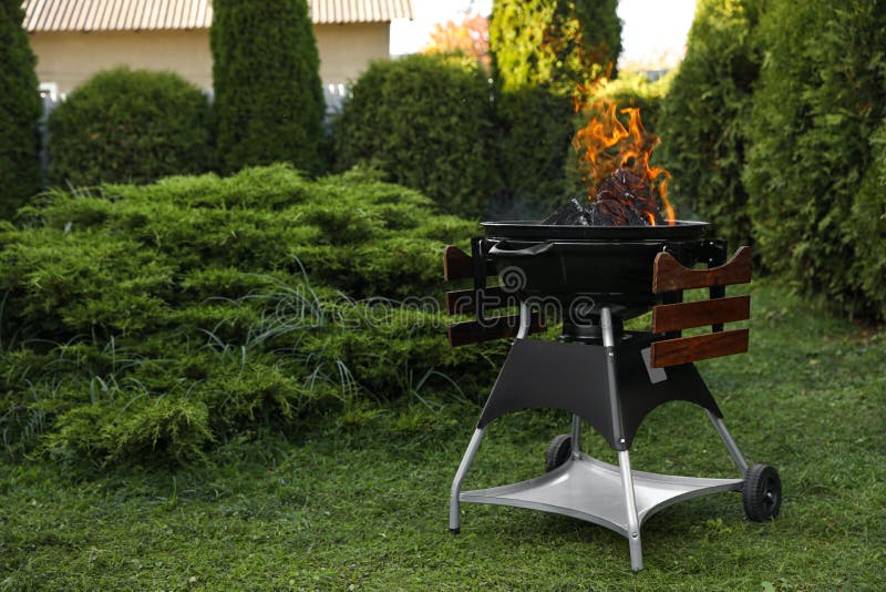 Portable Barbecue Grill with Fire Flames Outdoors. Space for Text Stock ...