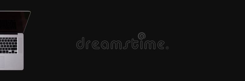 Portable Modern Silver Computer on a Black Background. Half the ...